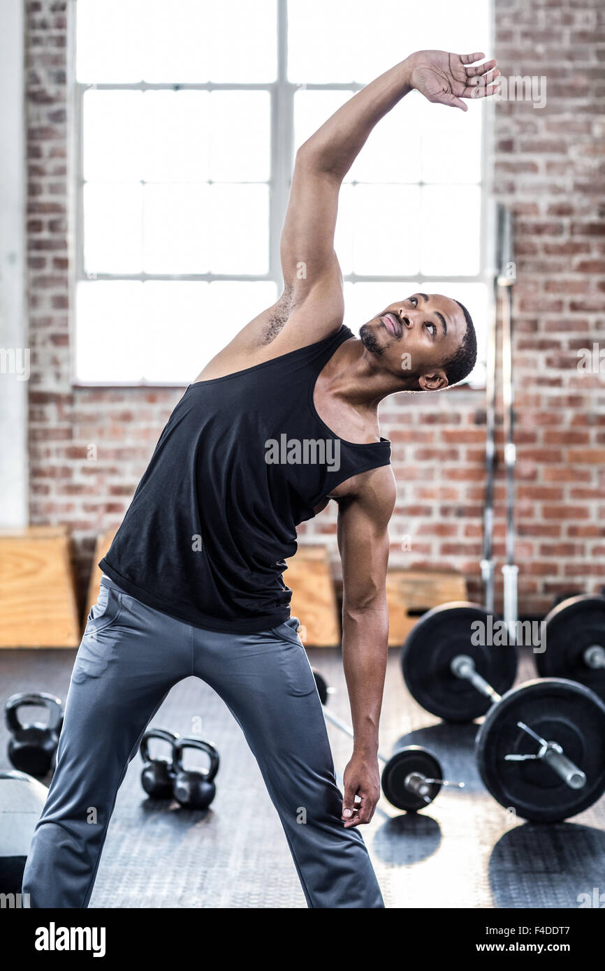 Muscular man doing stretching exercises Stock Photo - Alamy