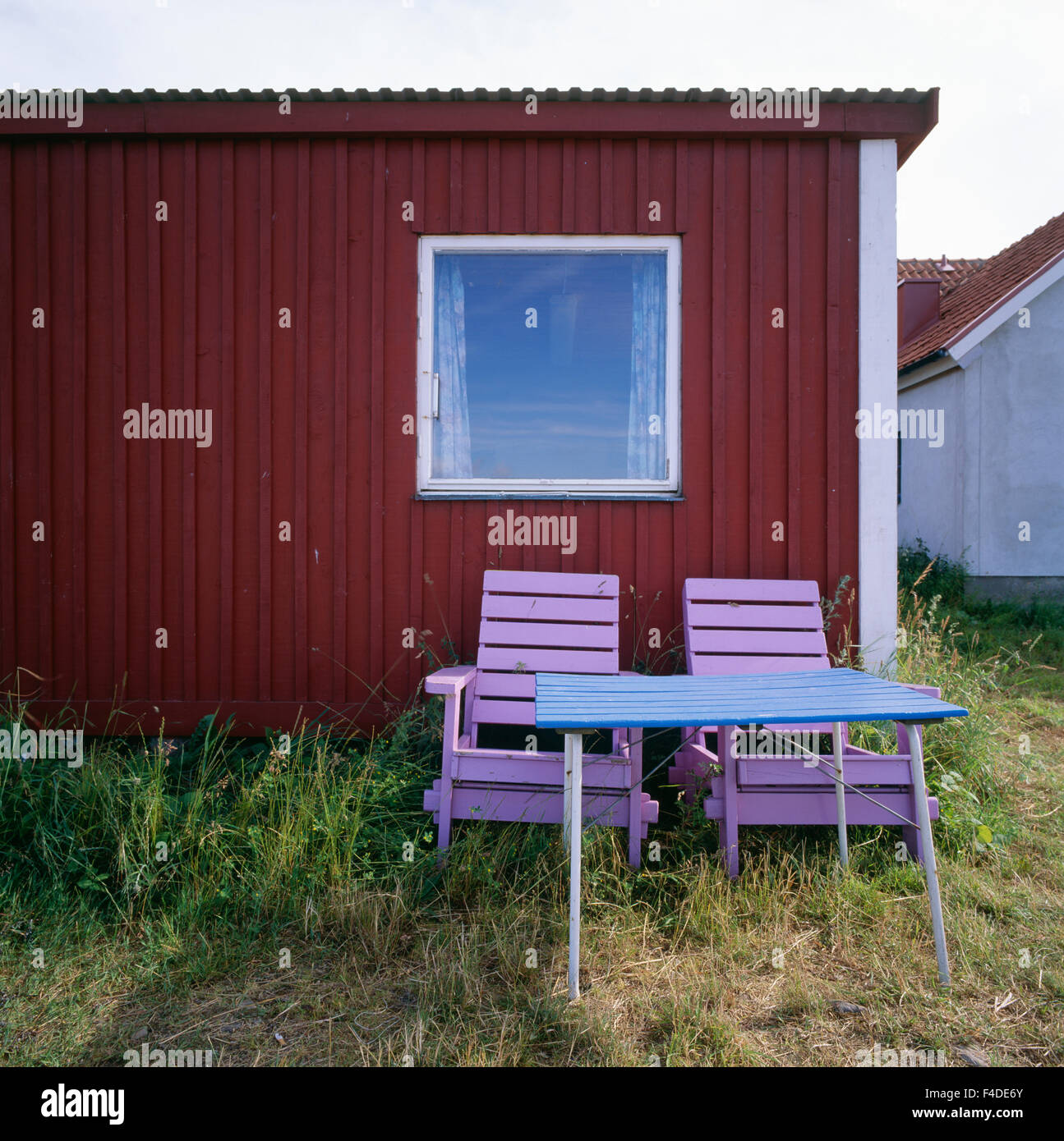 Table and chairs by house Stock Photo - Alamy