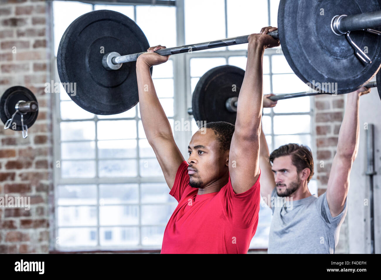 Fit people lifting barbell weight Stock Photo - Alamy