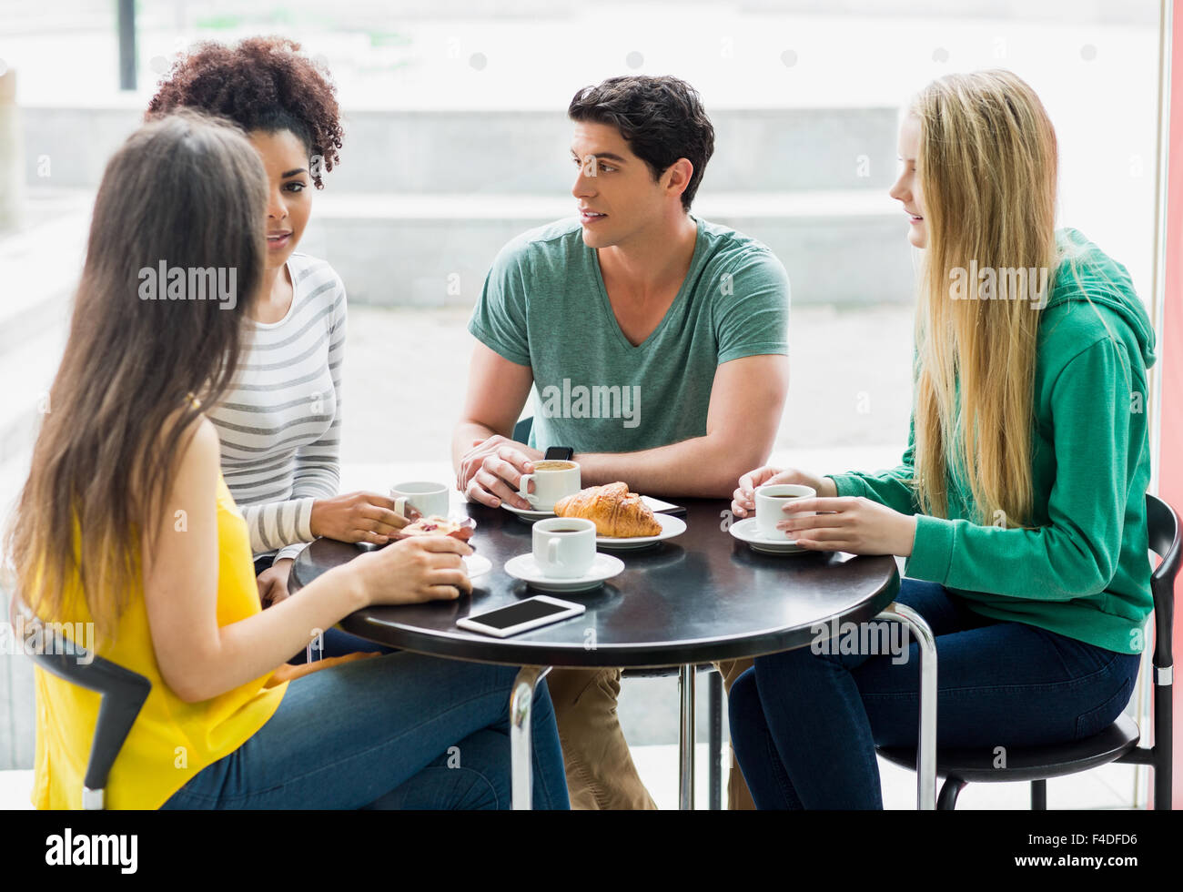 Happy students having coffee together Stock Photo - Alamy