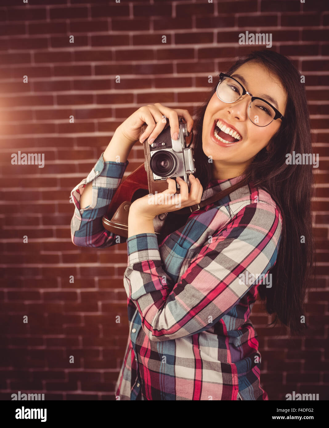 Attractive hipster holding a camera Stock Photo - Alamy
