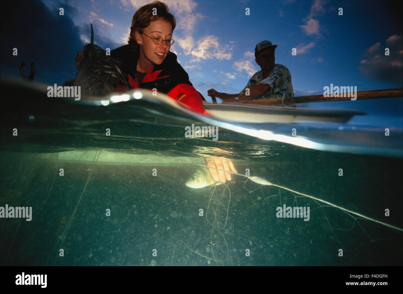 Woman catching fish hi-res stock photography and images - Alamy