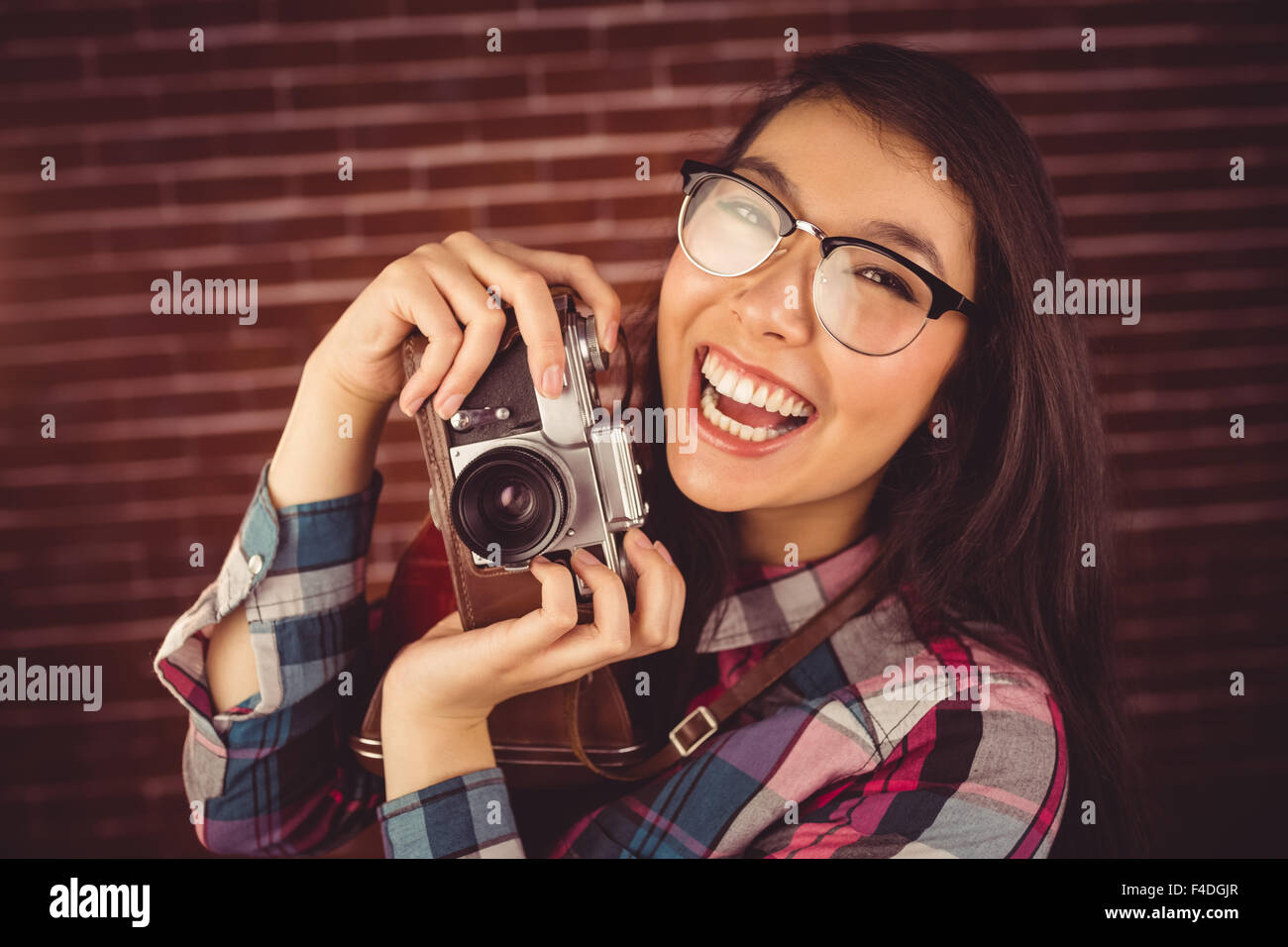 Attractive hipster holding a camera Stock Photo - Alamy