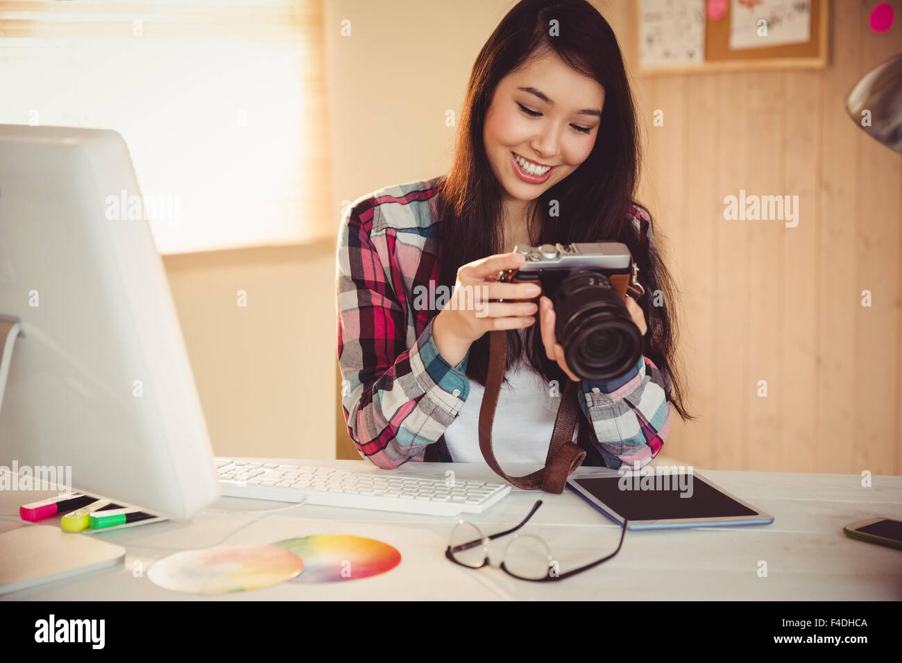 Happy photographer holding her camera Stock Photo - Alamy