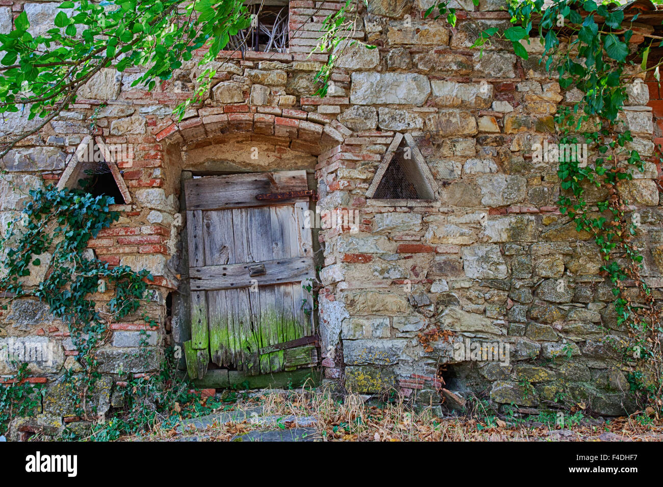 Old entry door in rock House Stock Photo - Alamy