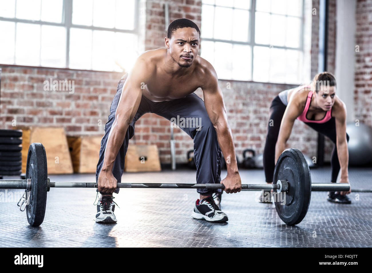 Fit couple lifting weight together Stock Photo - Alamy