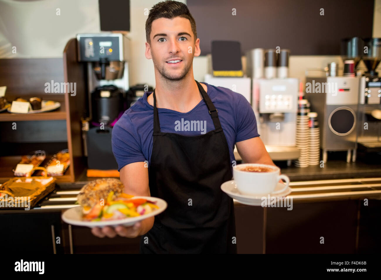Handsome waiter smiling at camera Stock Photo - Alamy