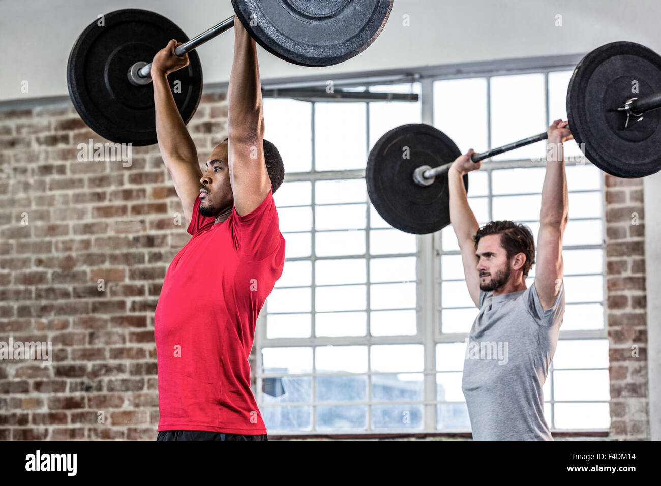 Fit people lifting barbell weight Stock Photo - Alamy