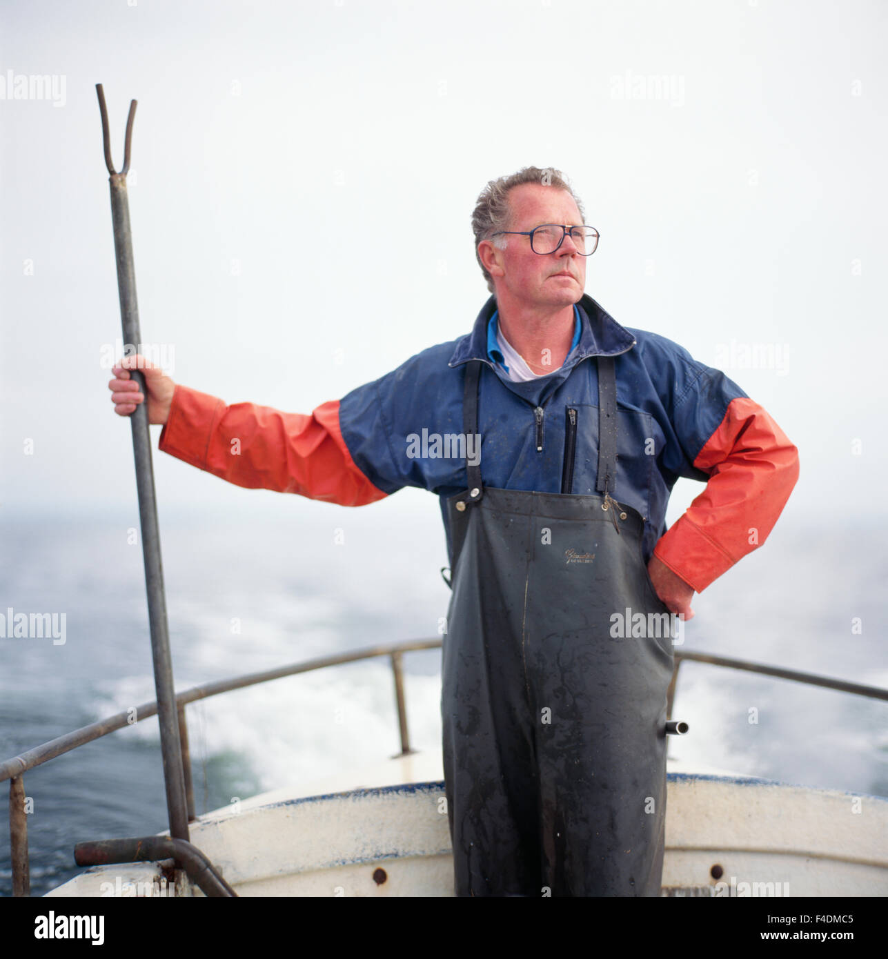 Man standing on boat Stock Photo - Alamy