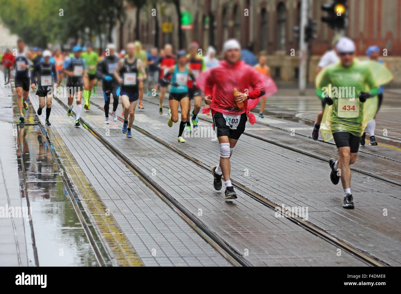 Marathon runners race in city streets, blurred motion Stock Photo - Alamy