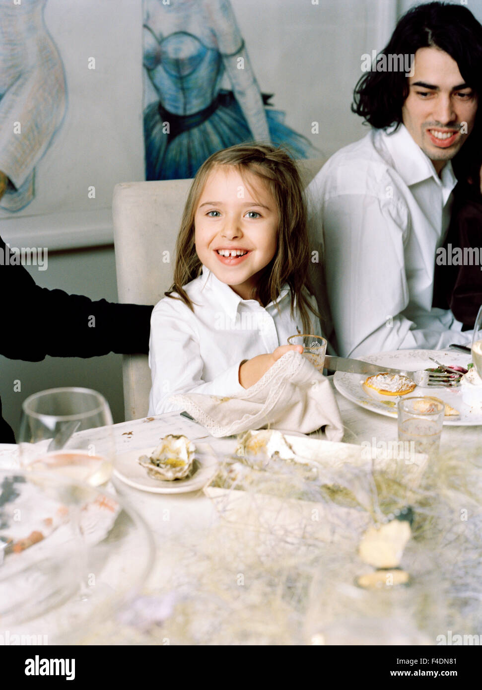 Girl sitting at a decorated dinner table Stock Photo - Alamy