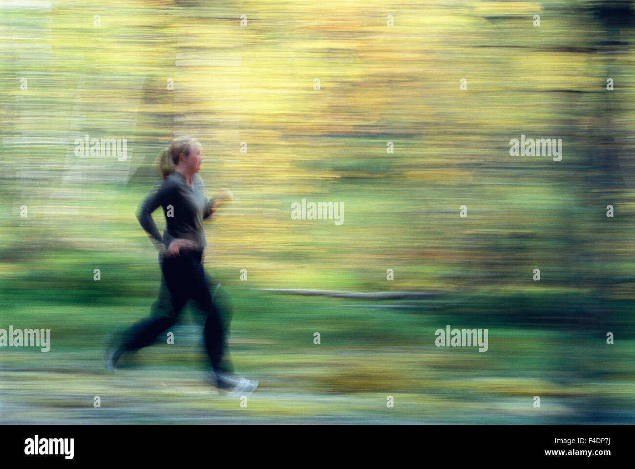 Female running in forest Stock Photo - Alamy