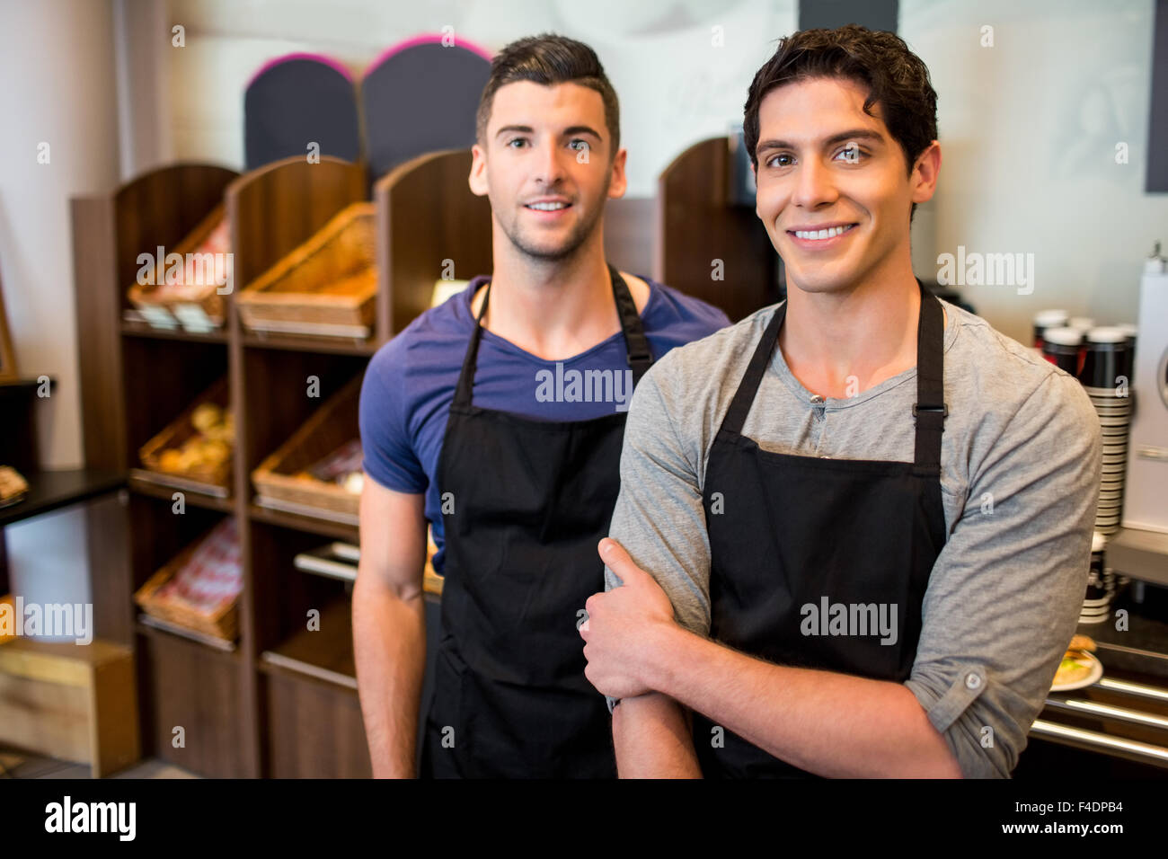 Handsome waiters smiling at camera Stock Photo - Alamy