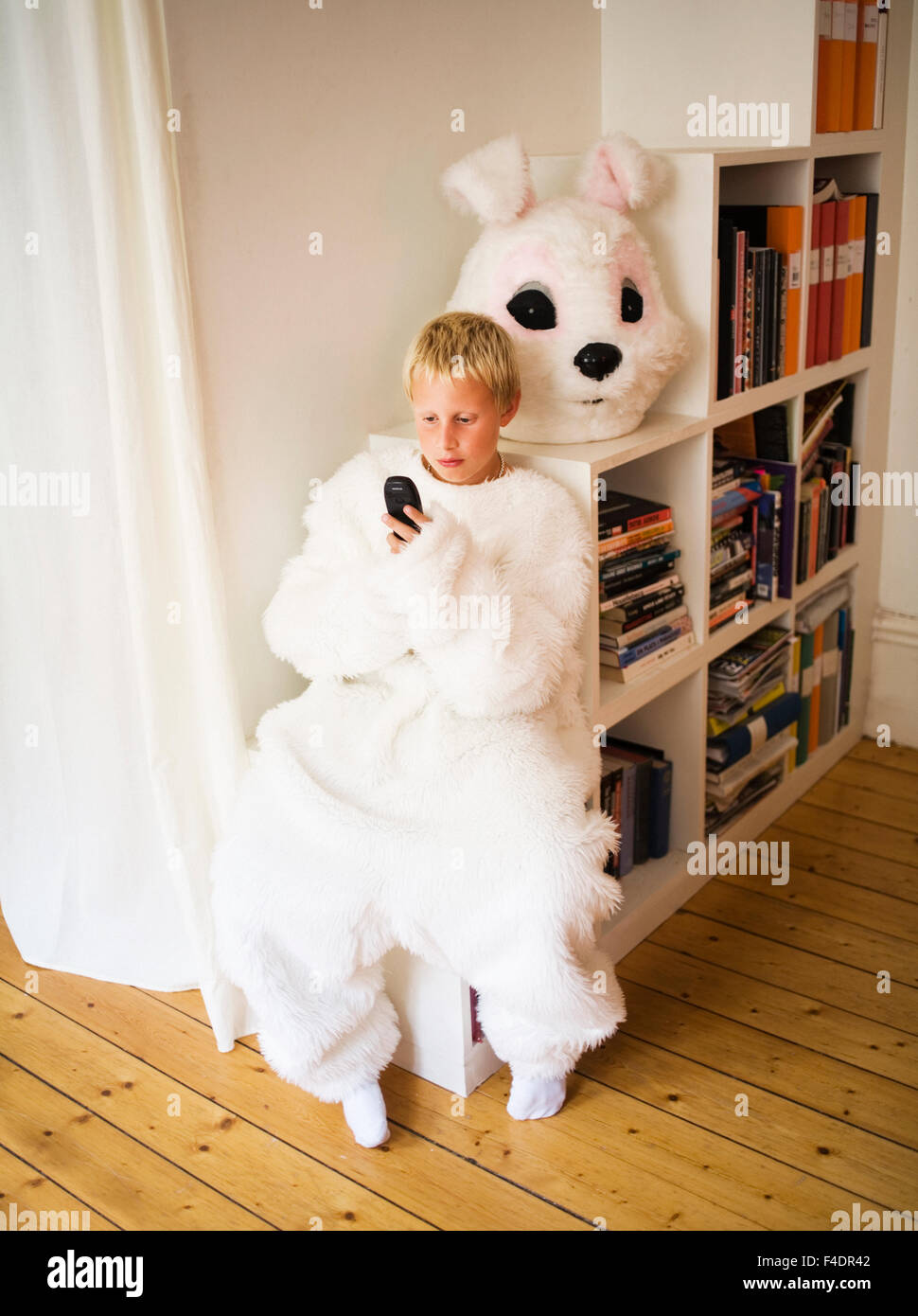 A boy in a bunny costume sending a text message Stock Photo - Alamy