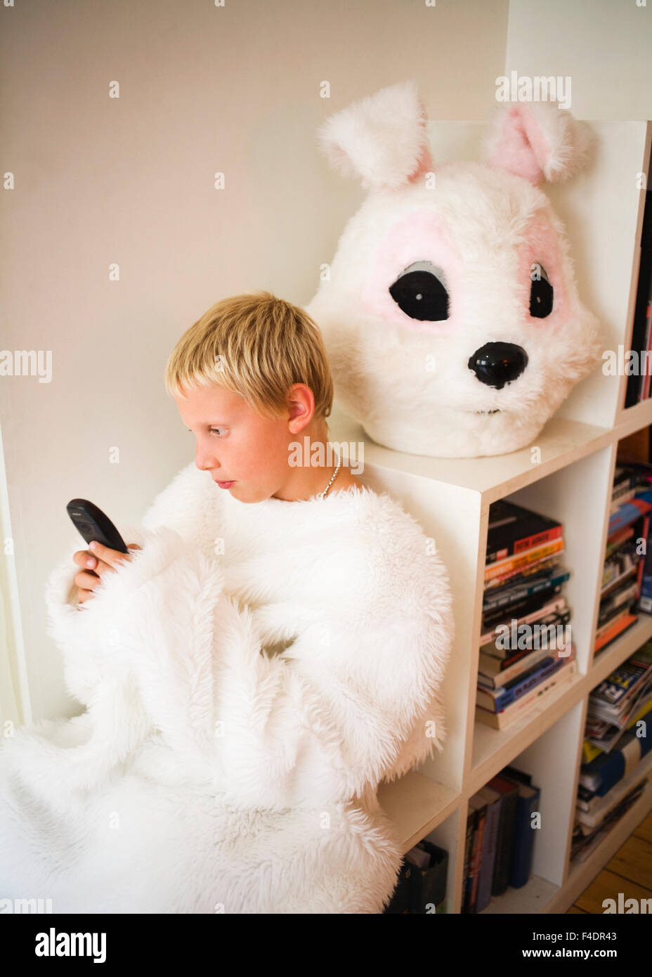 A boy in a bunny costume sending a text message Stock Photo - Alamy