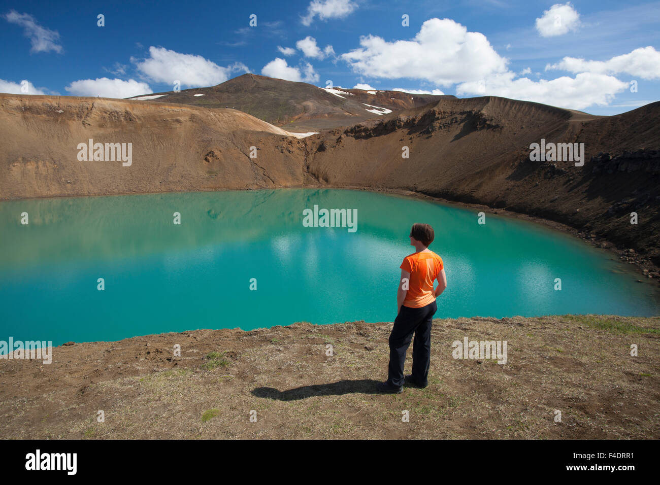 Visitor admiring Viti crater, Krafla volcanic area, Myvatn, Nordhurland ...