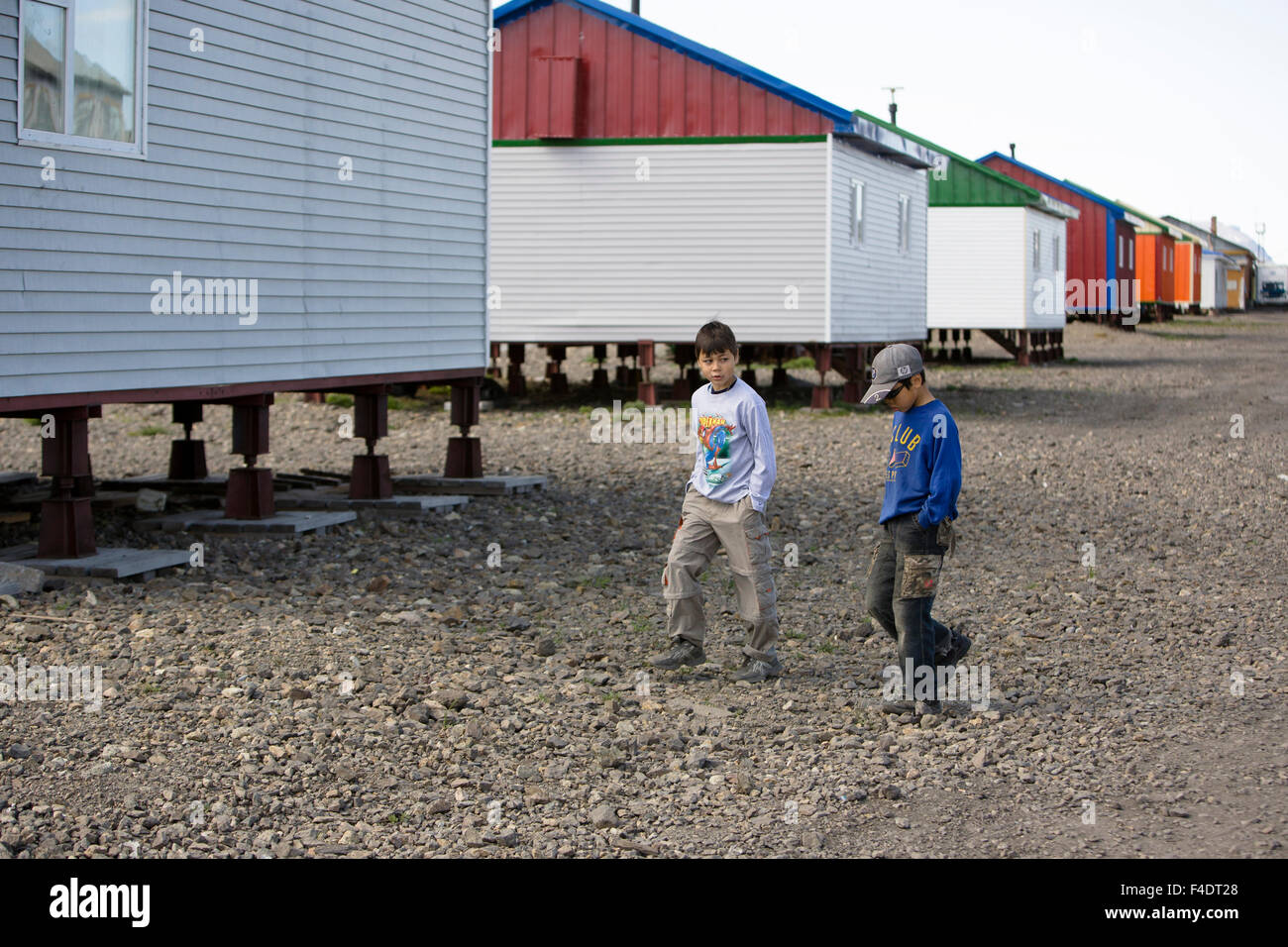 Russia, Chukotka, Chaplino Village, Boys walking by prefab houses in ...