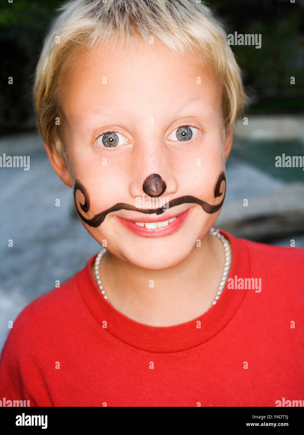 A boy with a painted moustache Stock Photo - Alamy