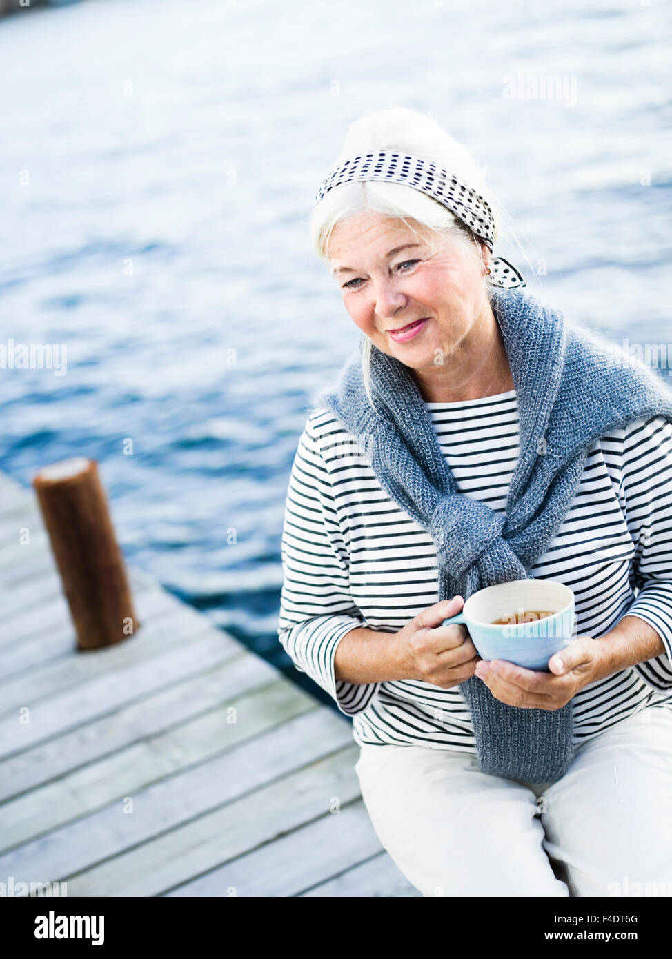 Older woman drinking tea outside hi-res stock photography and images ...