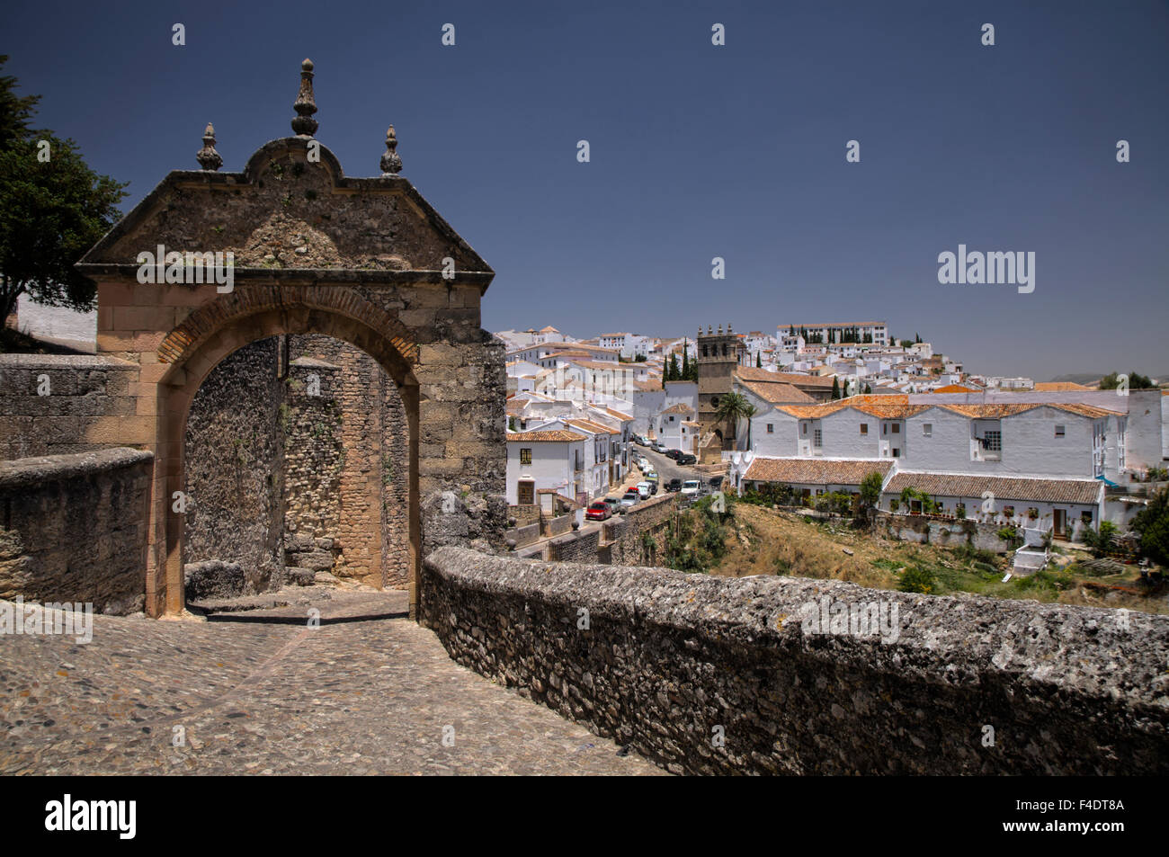 Spain, Andalusia, Malaga Province, Ronda. Stone archway entry to the ...
