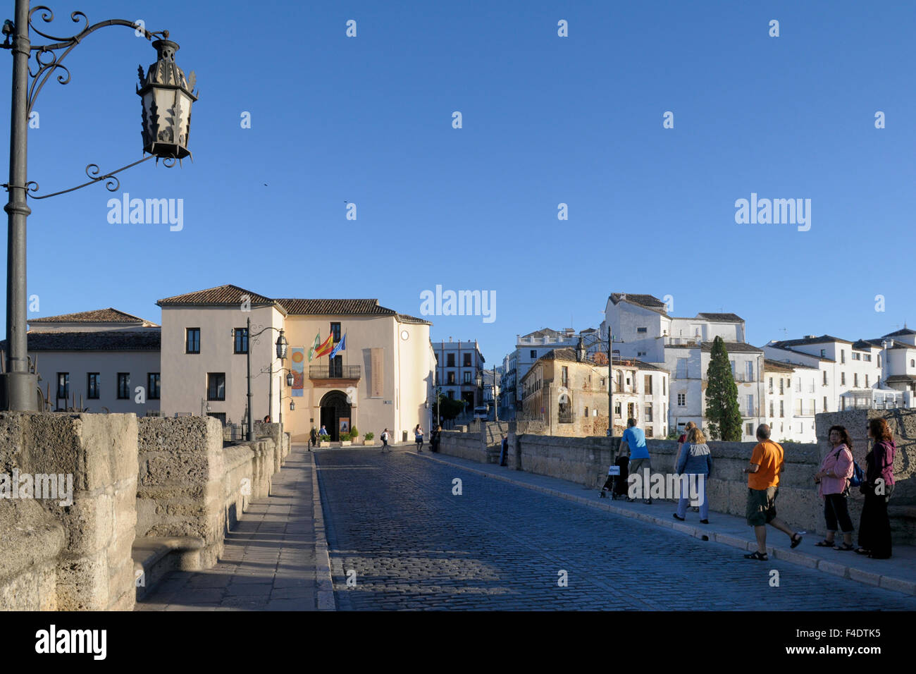 Europe, Spain, Andalusia, Malaga Province, Ronda. People walking across ...