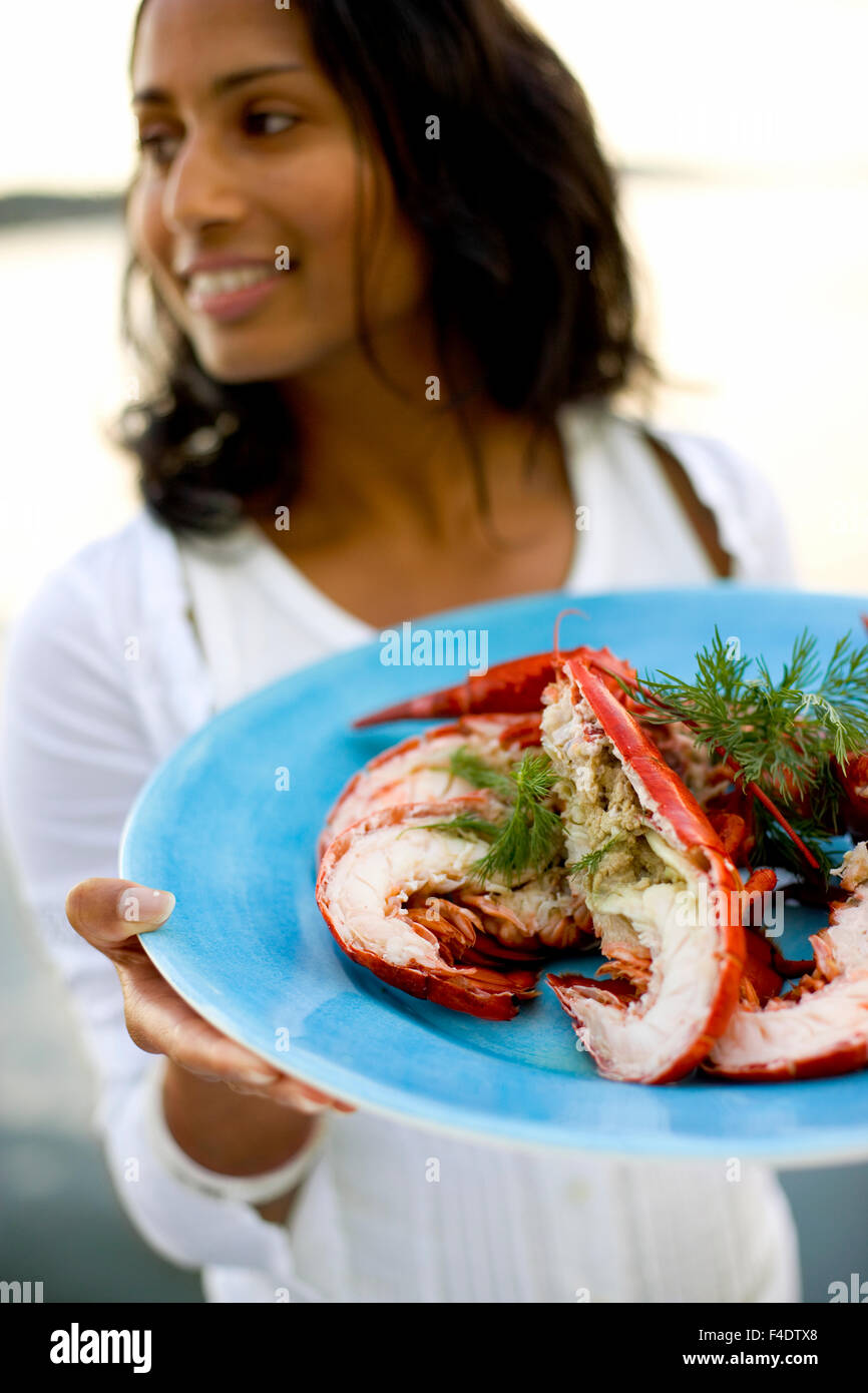 A woman serving lobster Stock Photo - Alamy