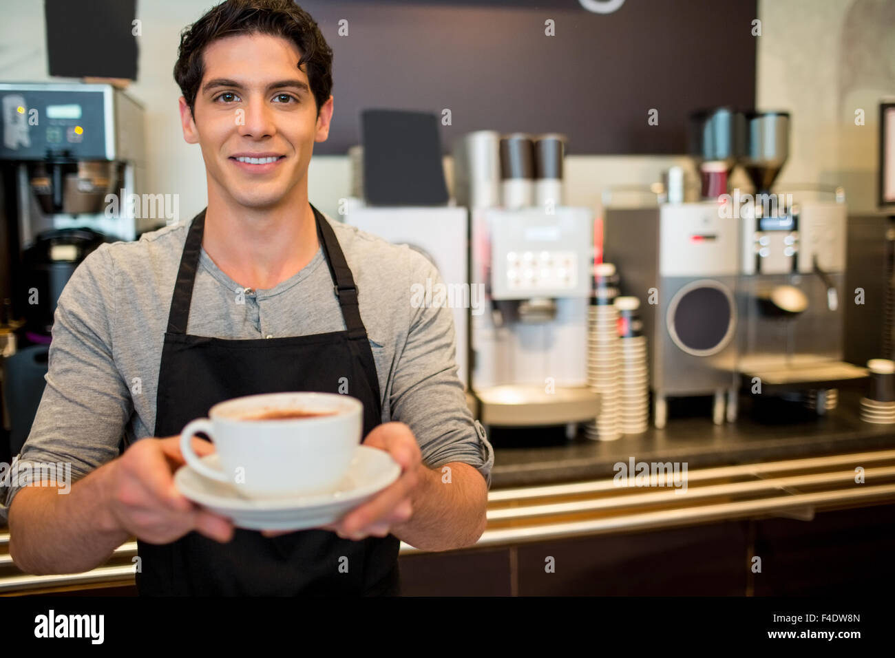 Handsome waiter smiling at camera Stock Photo - Alamy