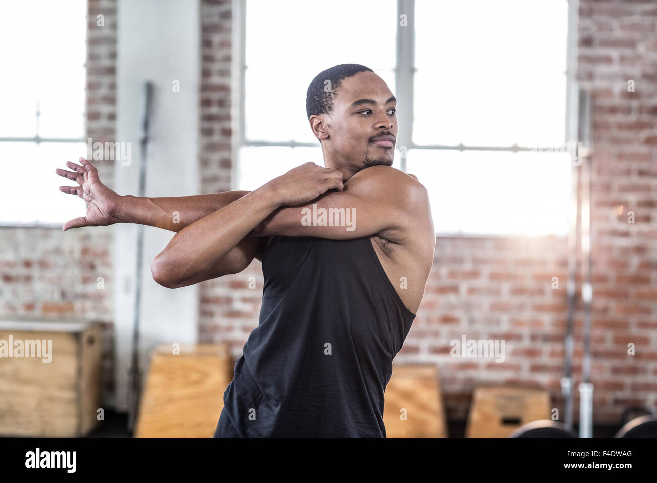 Muscular man doing stretching exercises Stock Photo - Alamy