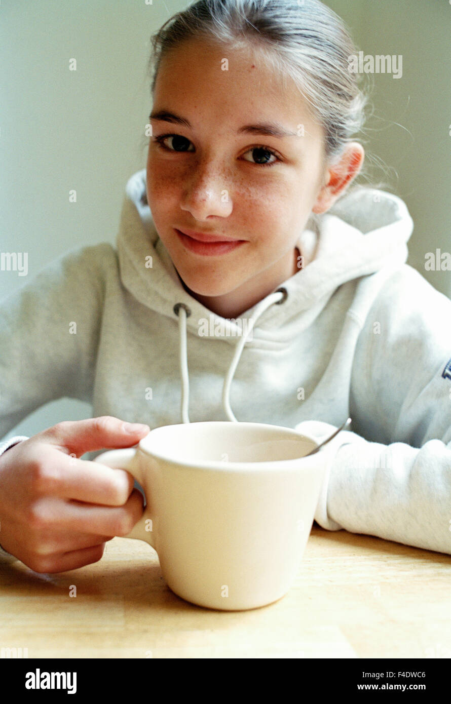 Teenage girl drinking tea Stock Photo - Alamy