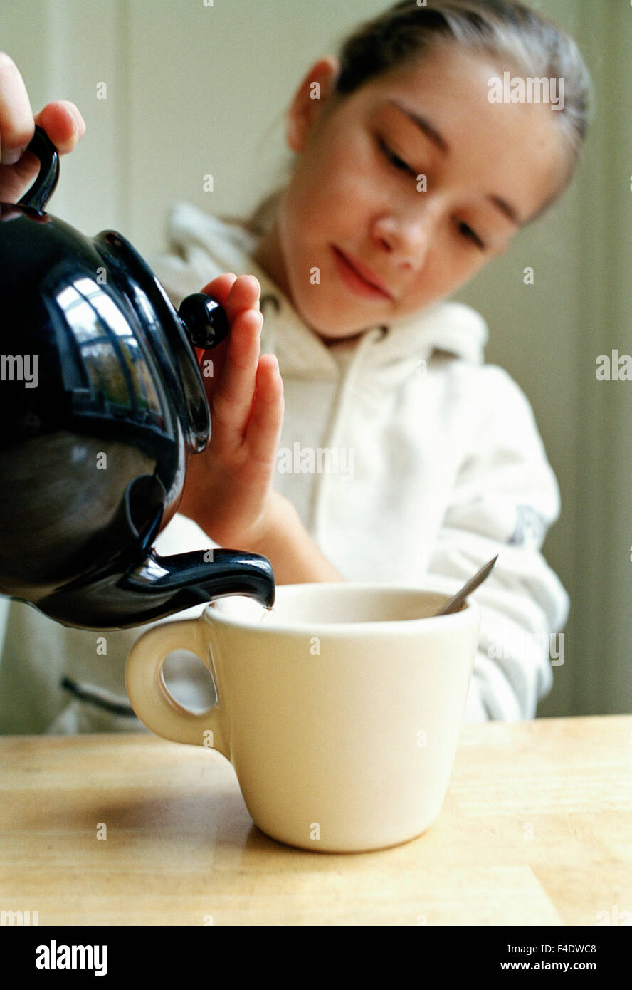 Teenage girl drinking tea Stock Photo - Alamy