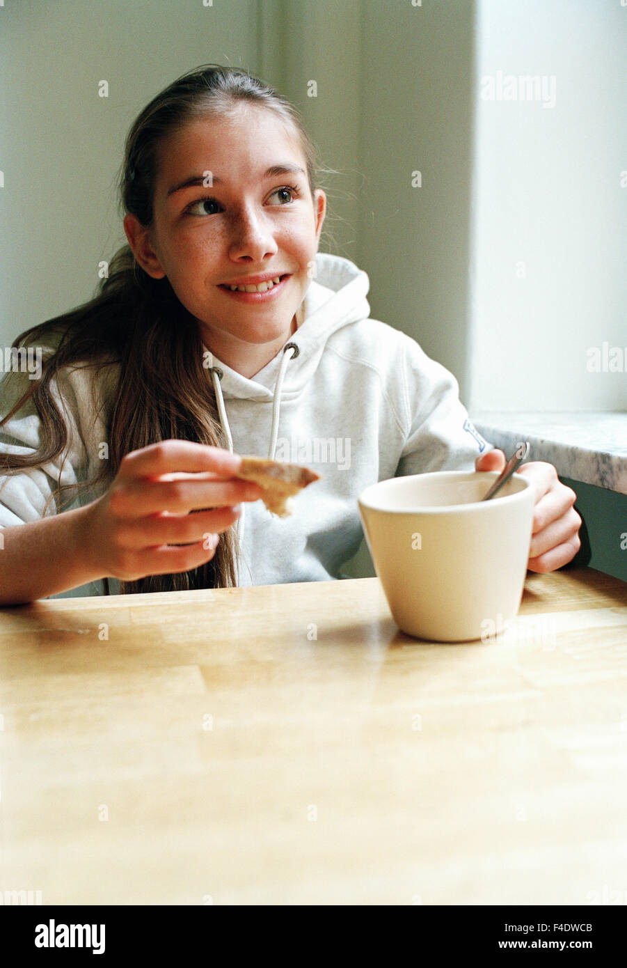 A teenage girl drinking tea Stock Photo - Alamy