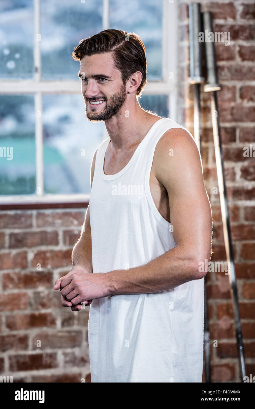 Fit man smiling in the studio Stock Photo - Alamy