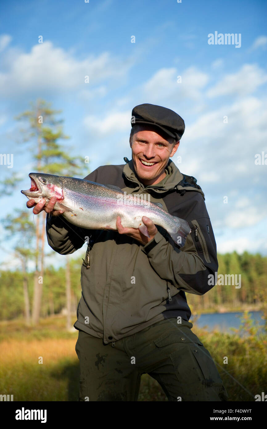 A smiling man holding a fish Stock Photo - Alamy