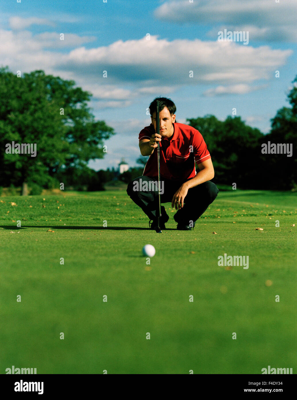 Golfer lining up putt hi-res stock photography and images - Alamy