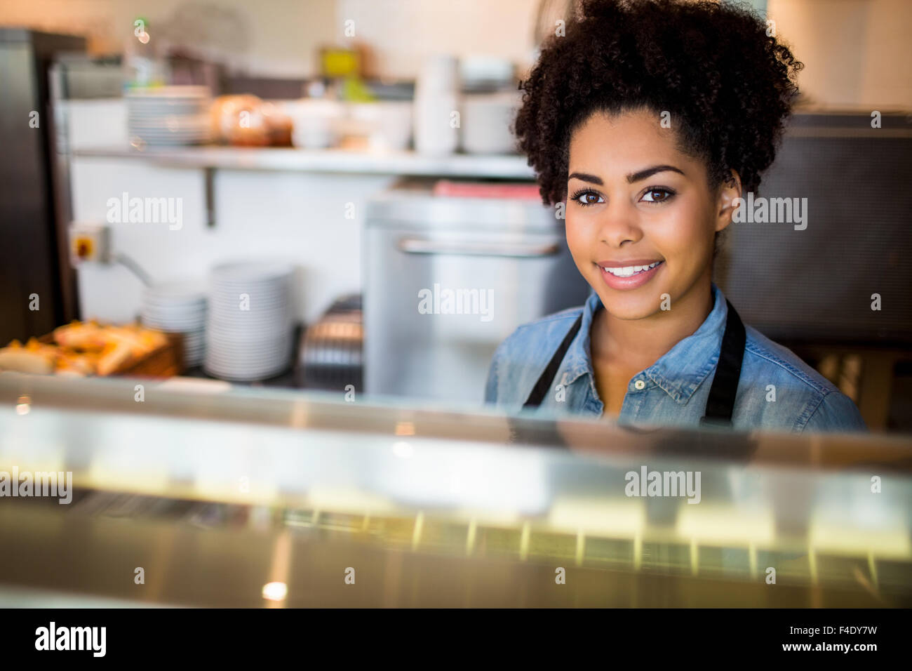 Pretty waitress smiling at camera Stock Photo - Alamy