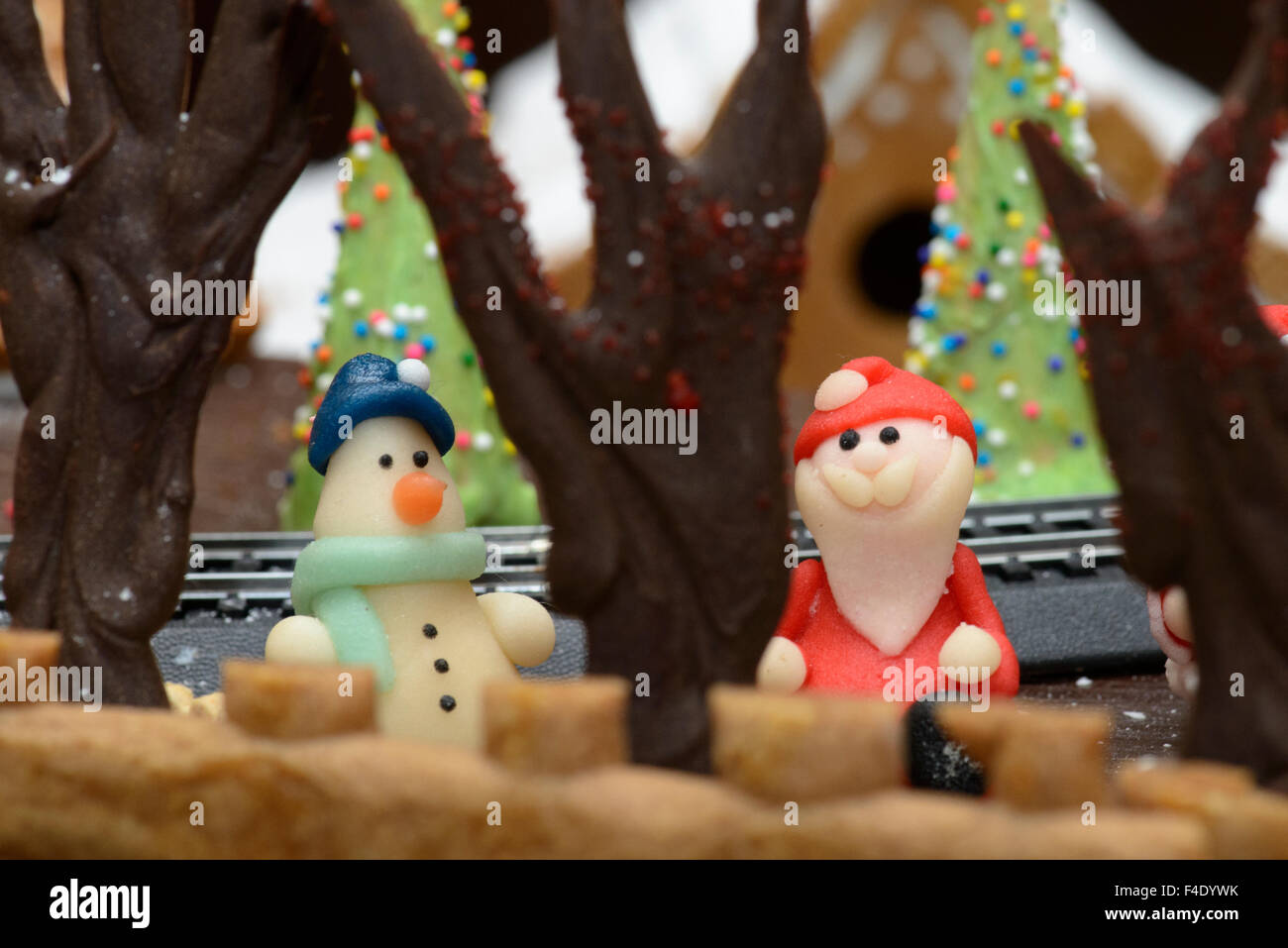 Marzipan Santa and snowman in gingerbread village Stock Photo - Alamy