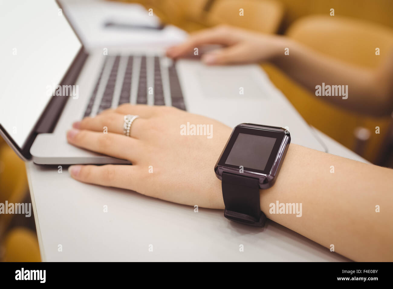 Pretty student in lecture hall with smartwatch Stock Photo - Alamy