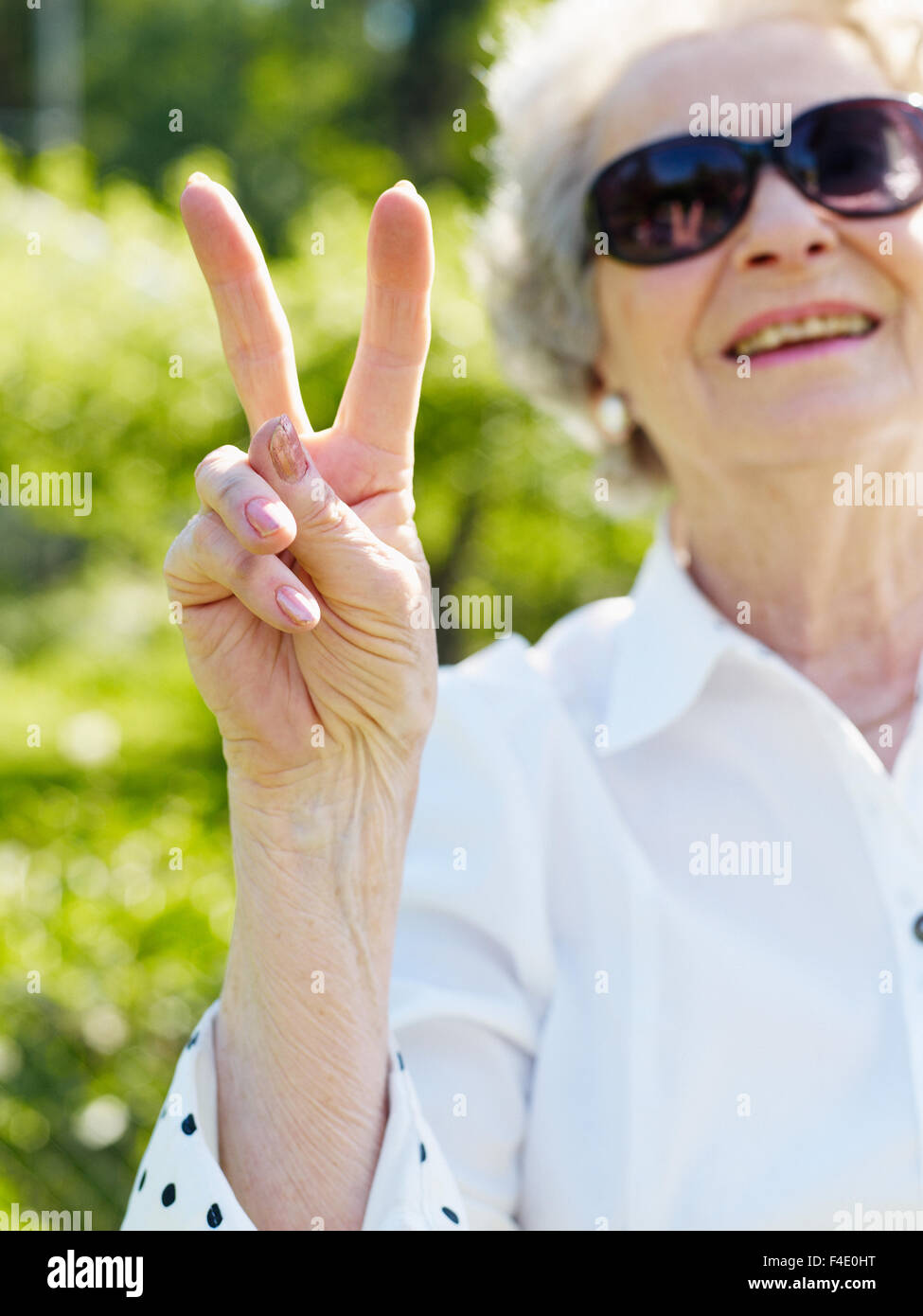 Woman making peace sign hi-res stock photography and images - Alamy