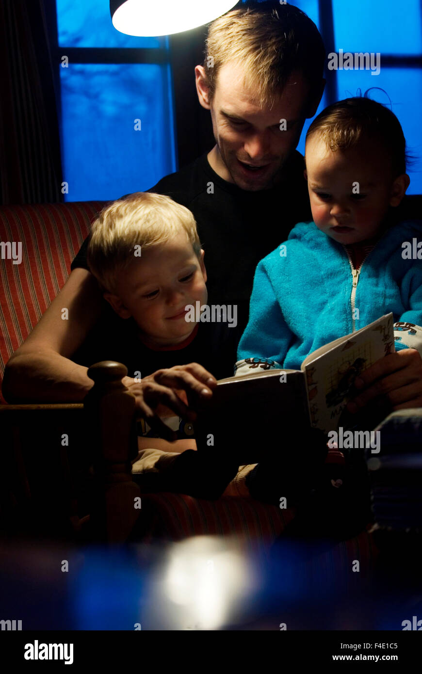 Father reading a book for his children, Sweden Stock Photo - Alamy