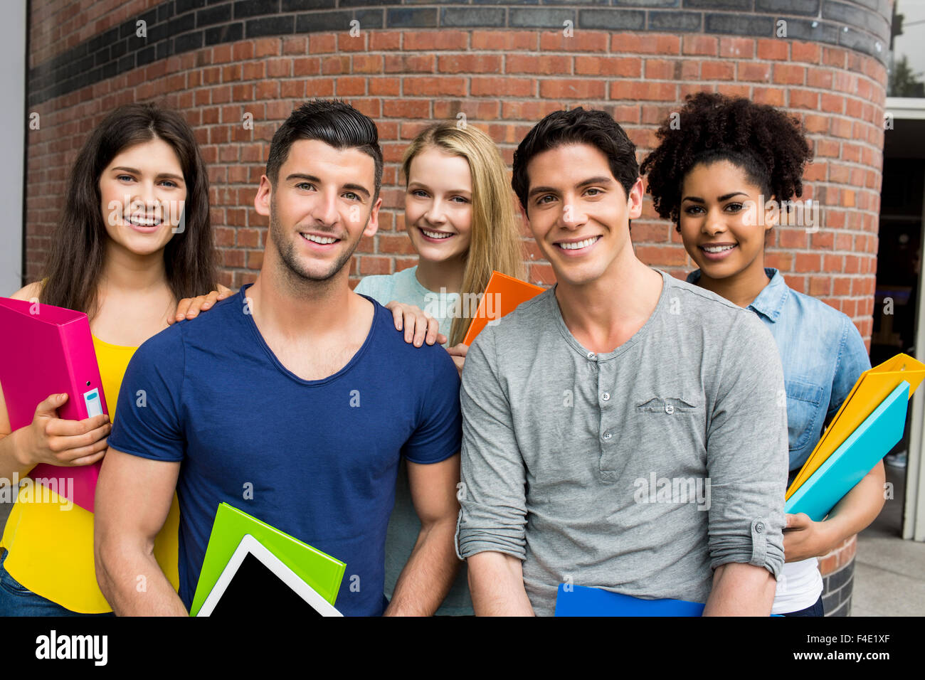 Students smiling at the camera Stock Photo - Alamy