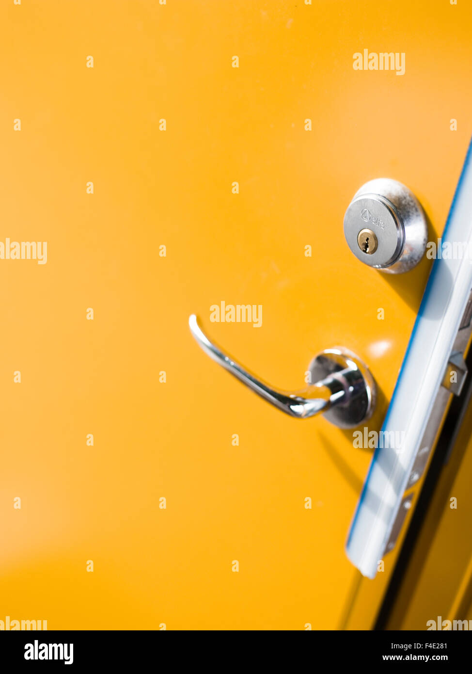 Doorhandle on a yellow door, close-up Stock Photo - Alamy