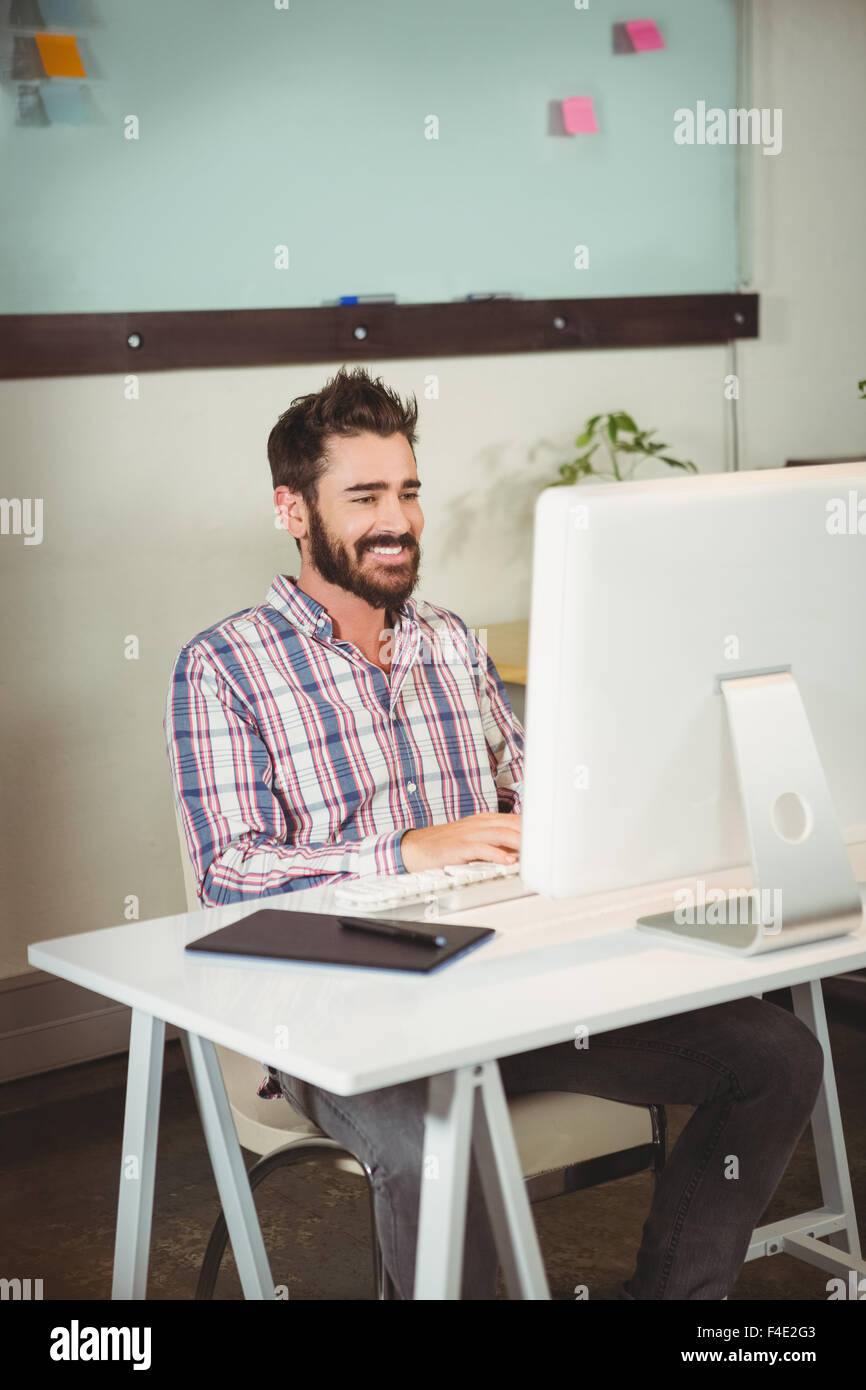 Businessman smiling at computer hi-res stock photography and images - Alamy