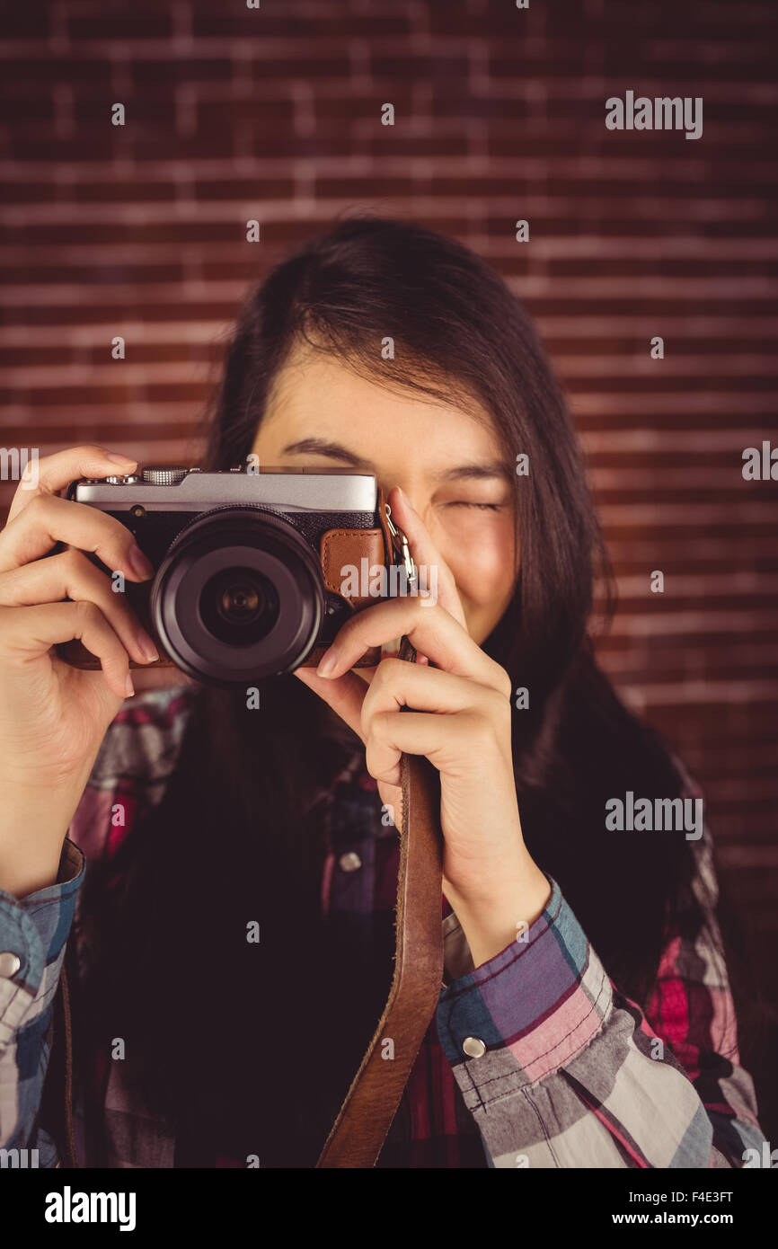 Attractive hipster photographing with camera Stock Photo - Alamy