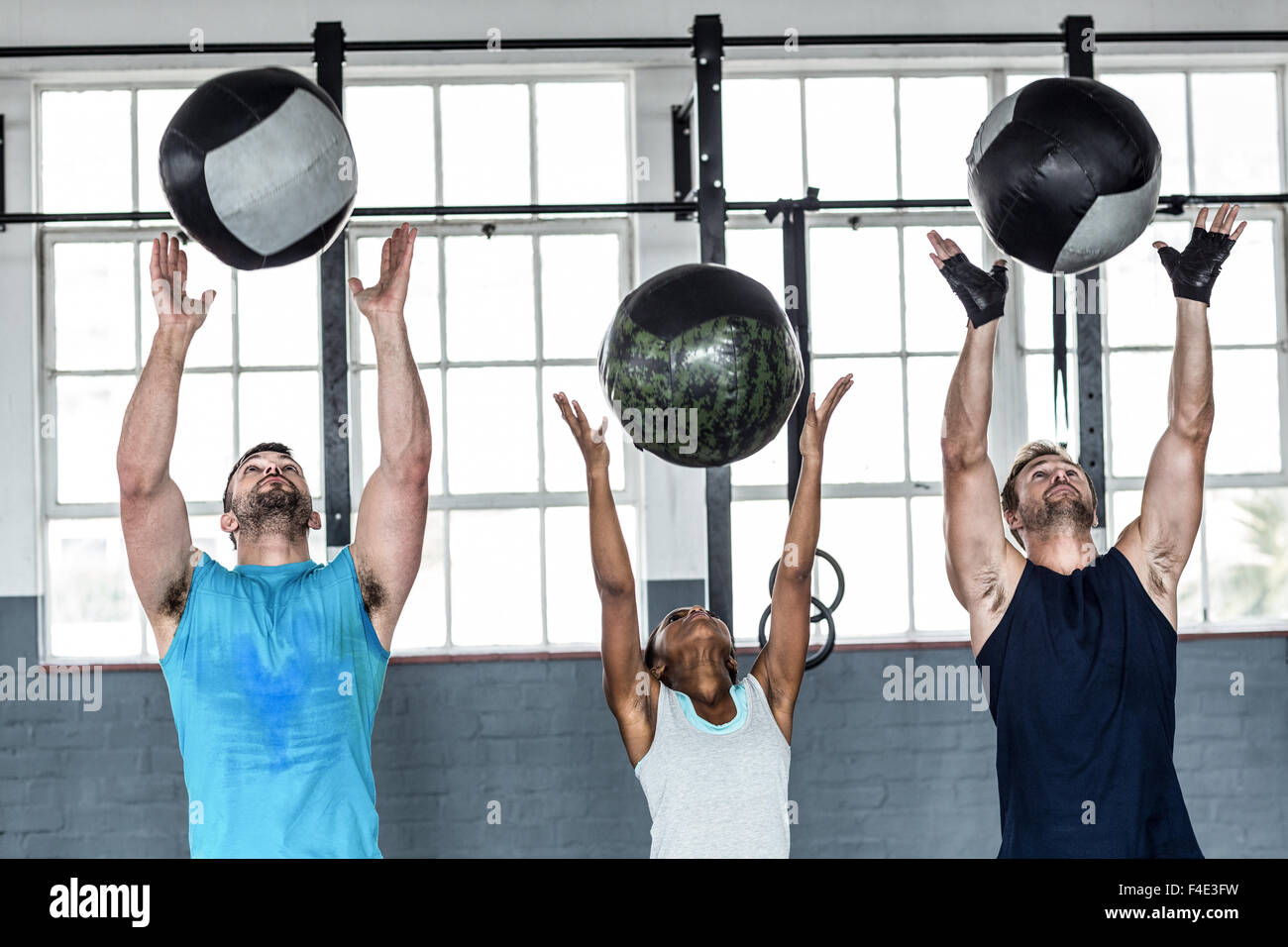 Muscular people doing ball exercise together Stock Photo - Alamy