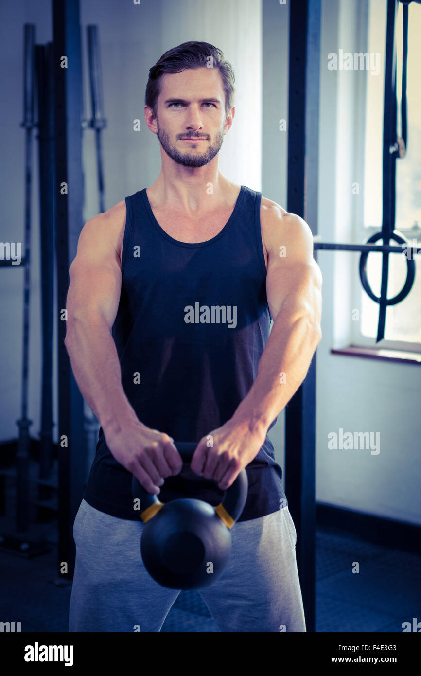 Fit man working out with kettlebell Stock Photo - Alamy