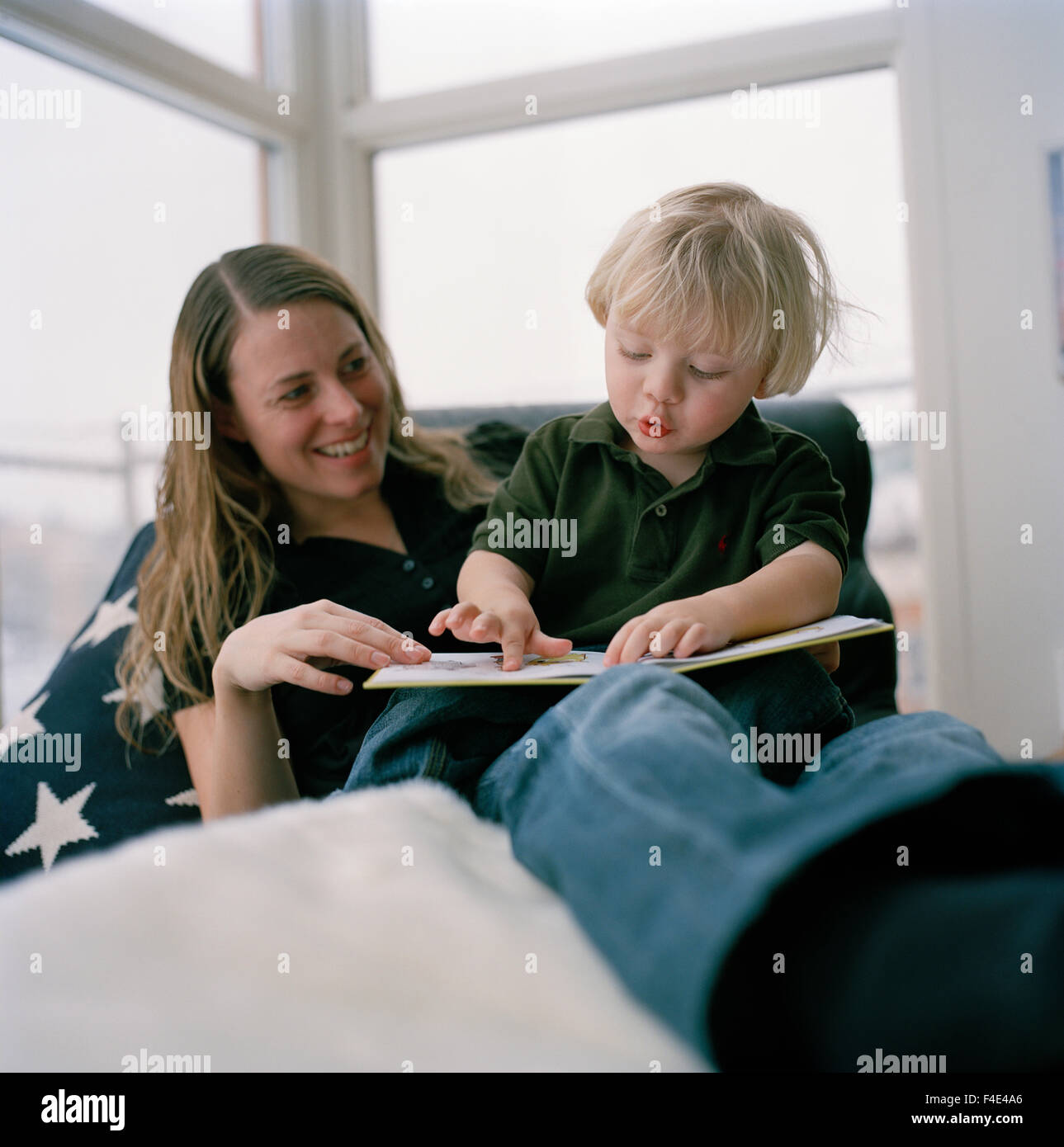 Mother and child reading a book, Sweden Stock Photo - Alamy