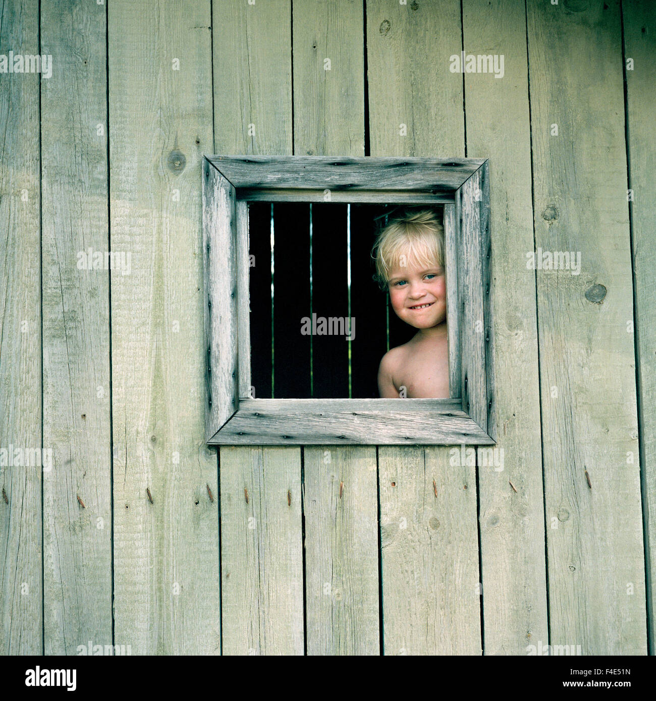 A girl in a window, Sweden Stock Photo - Alamy