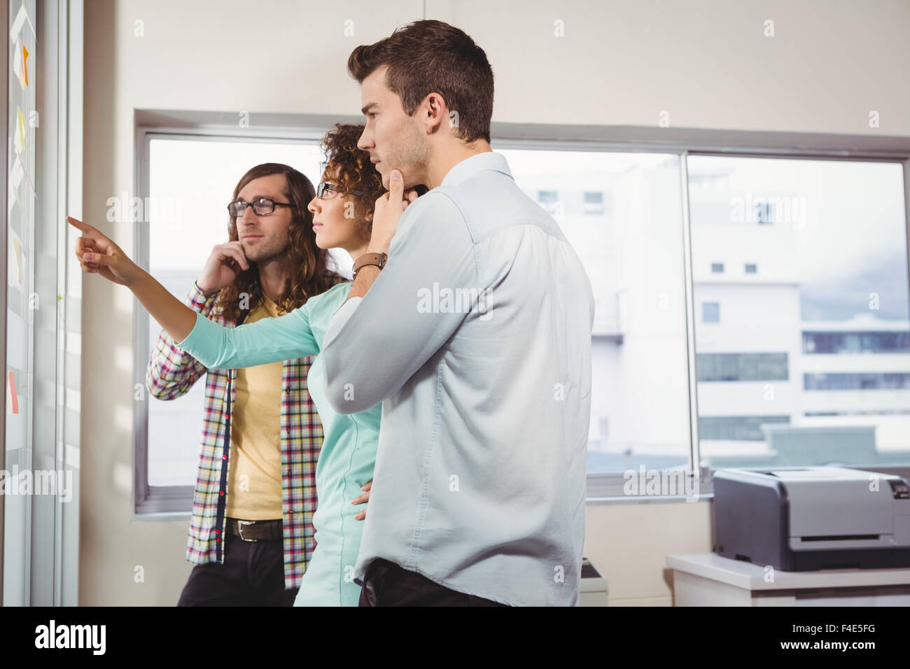 Creative businesswoman explaining colleagues in office Stock Photo - Alamy
