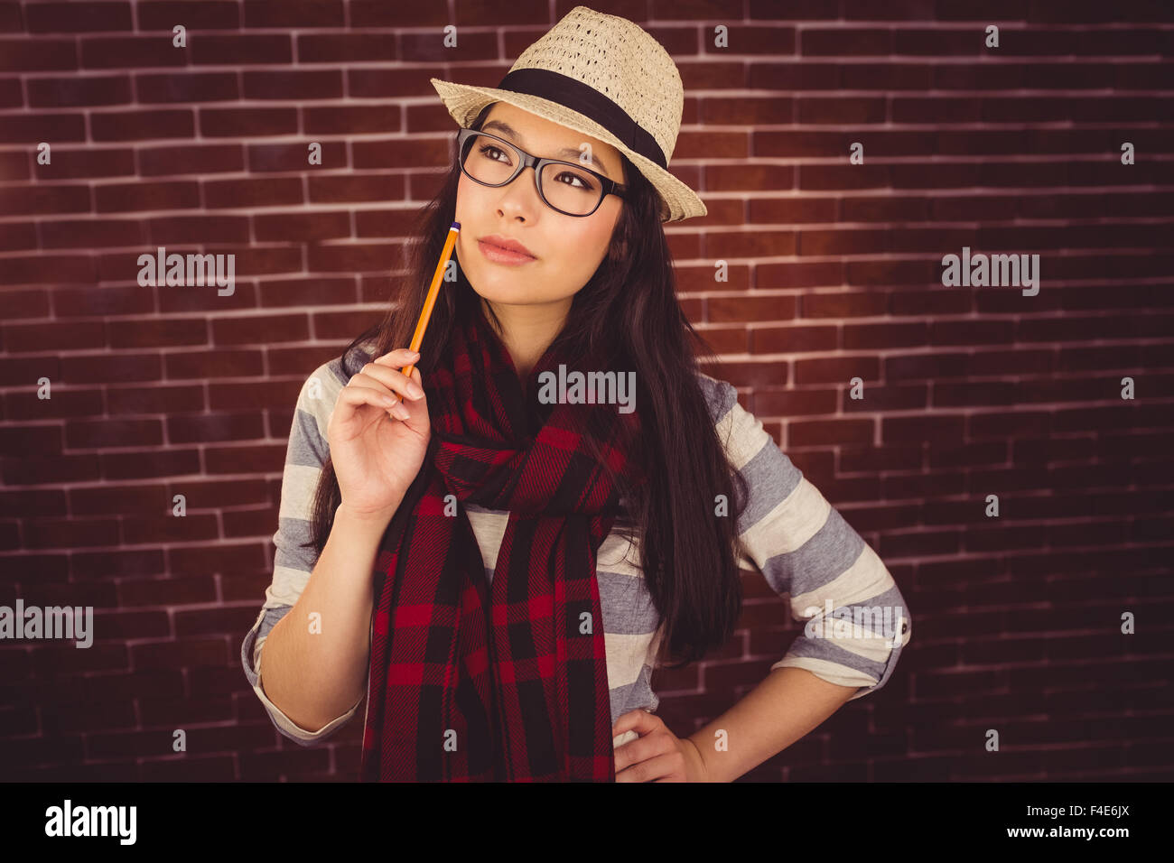 Attractive hipster posing with a pencil Stock Photo - Alamy
