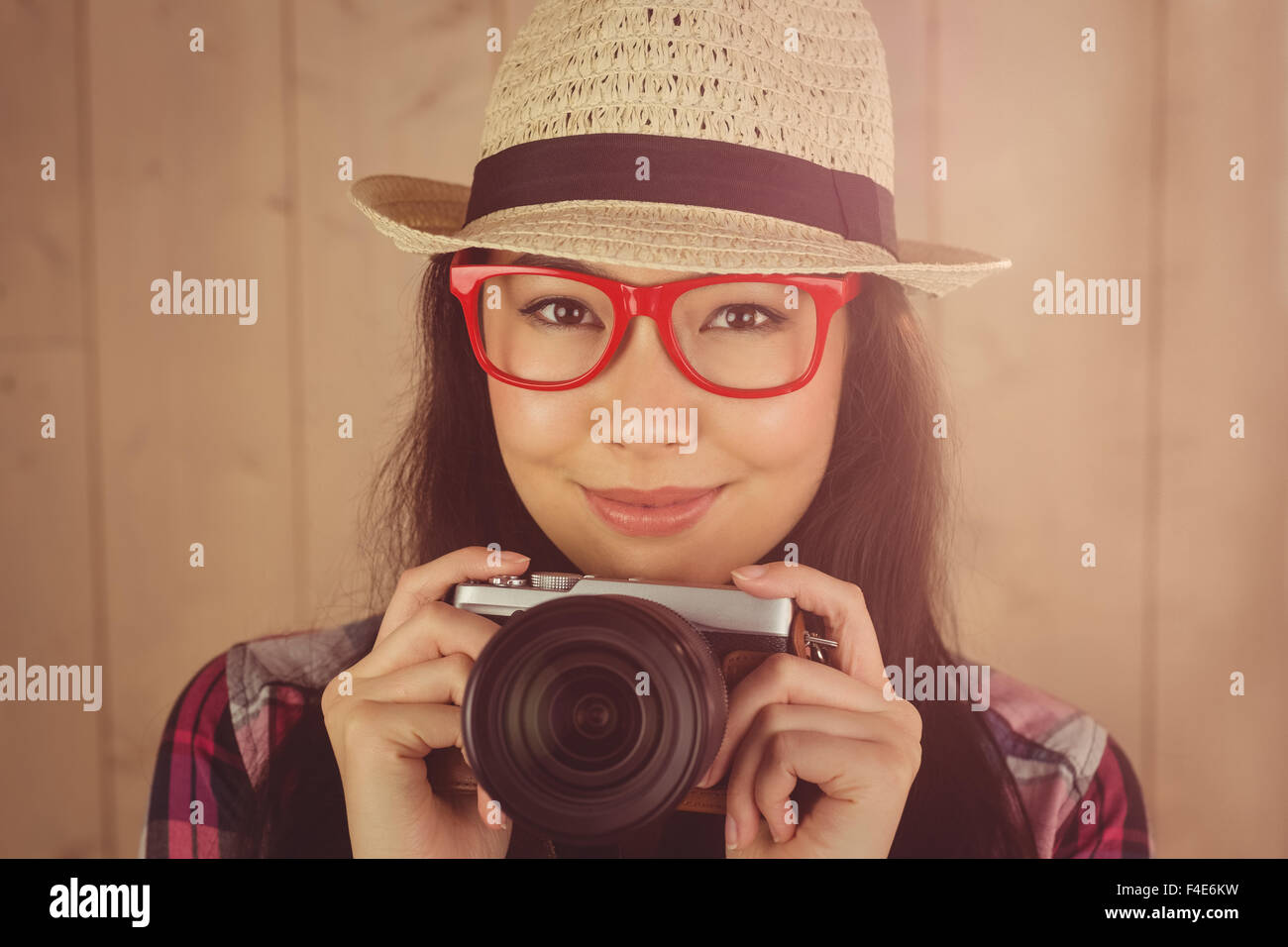 Attractive smiling hipster holding her camera Stock Photo - Alamy